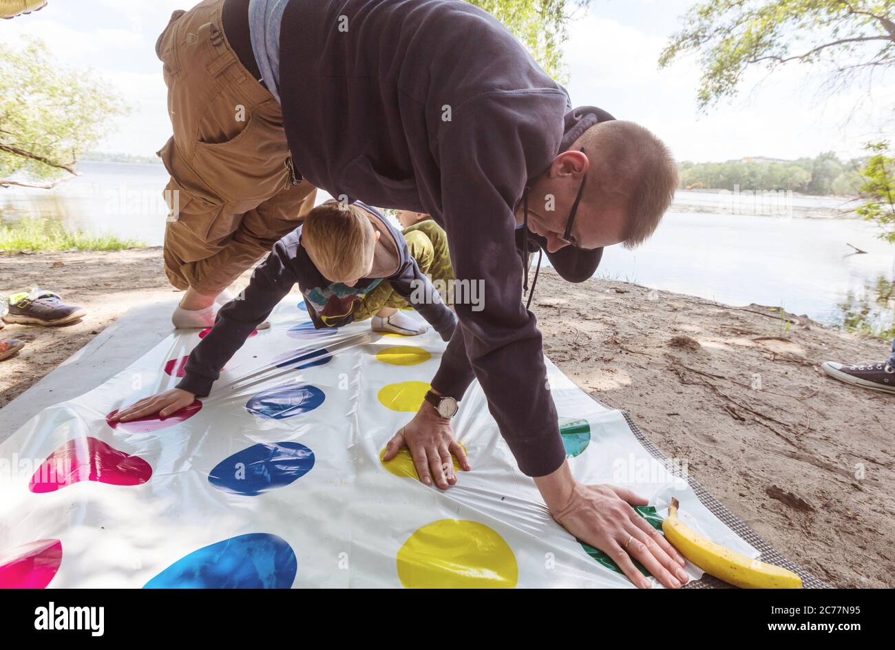 Kids playing twister game outdoors Stock Photo - Alamy