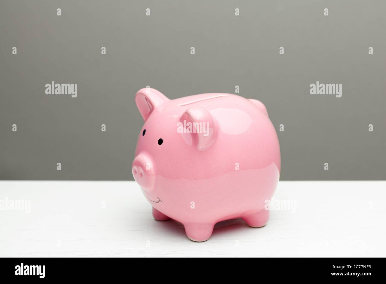 Pink piggy bank on a gray background. Copy space for text Stock Photo ...