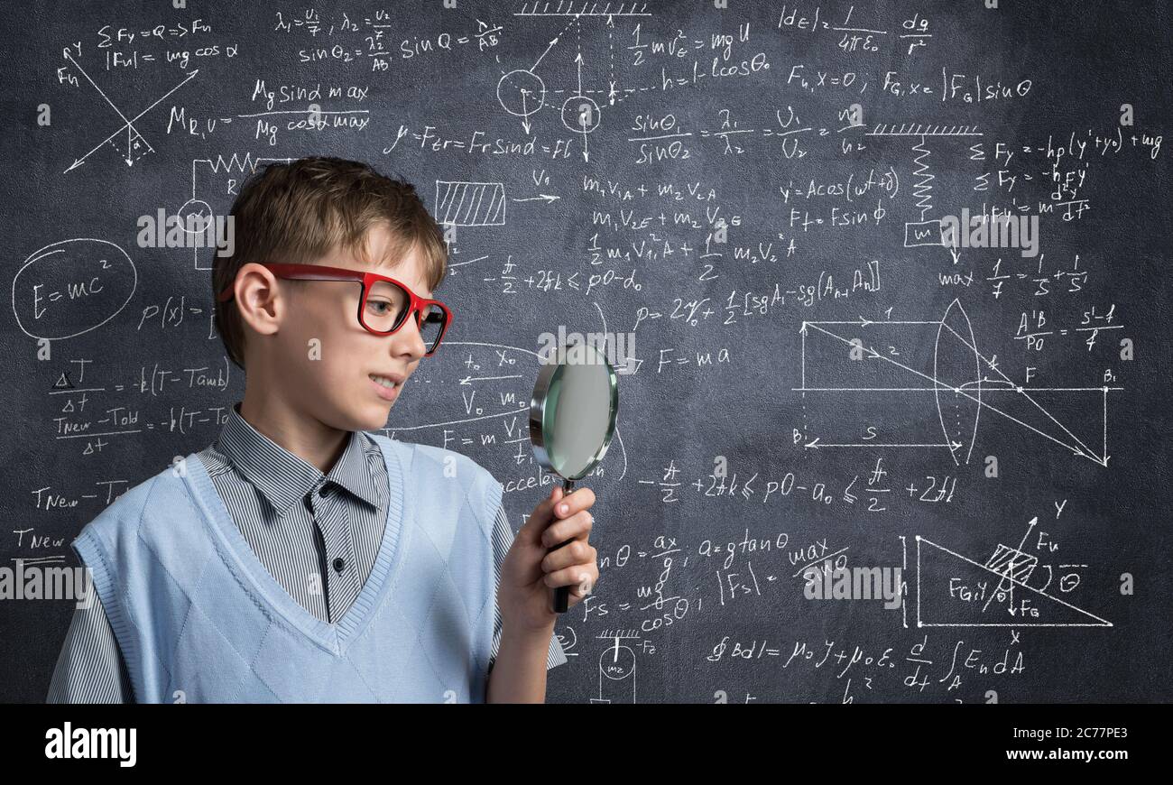 Curious school boy with magnifier Stock Photo - Alamy