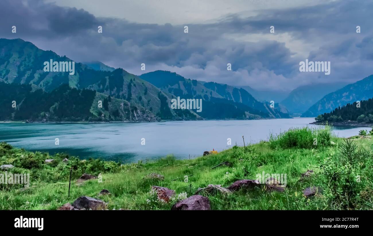 Tianchi Lake in the summer and Bogda peak in the distance Stock Photo ...