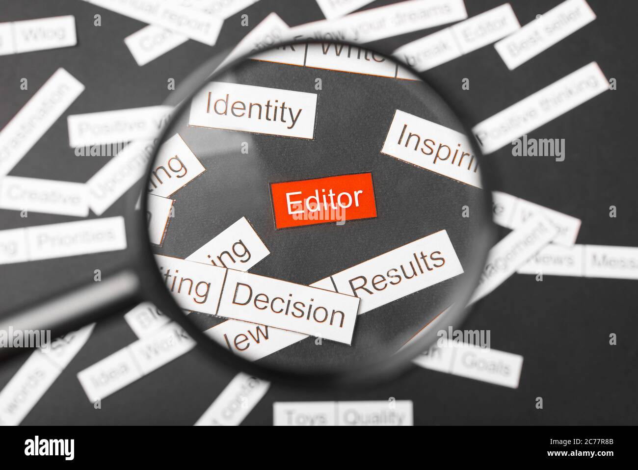 Magnifier glass over the red inscription editor cut out of paper ...