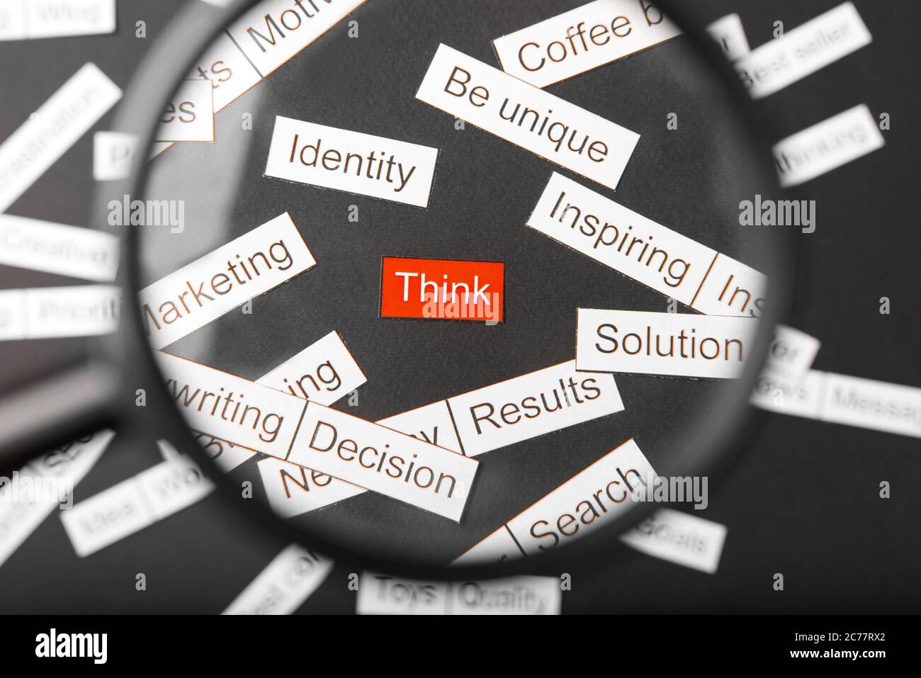 Magnifier glass over the red inscription think cut out of paper ...