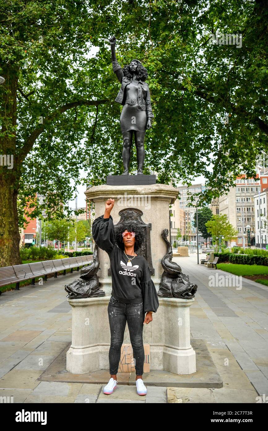 Jen Reid poses in front of her black resin and steel statue titled A ...