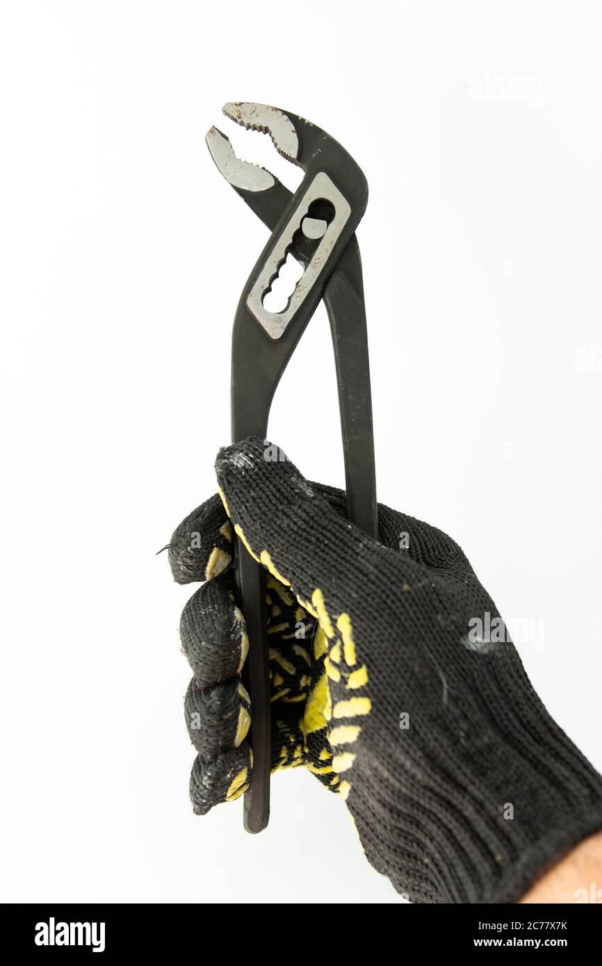 adjustable spanner in the hand of builder Stock Photo - Alamy