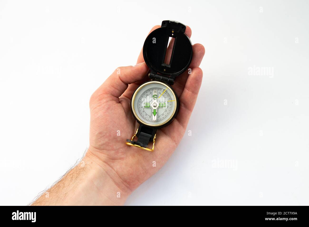 compass in hand on white background Stock Photo - Alamy