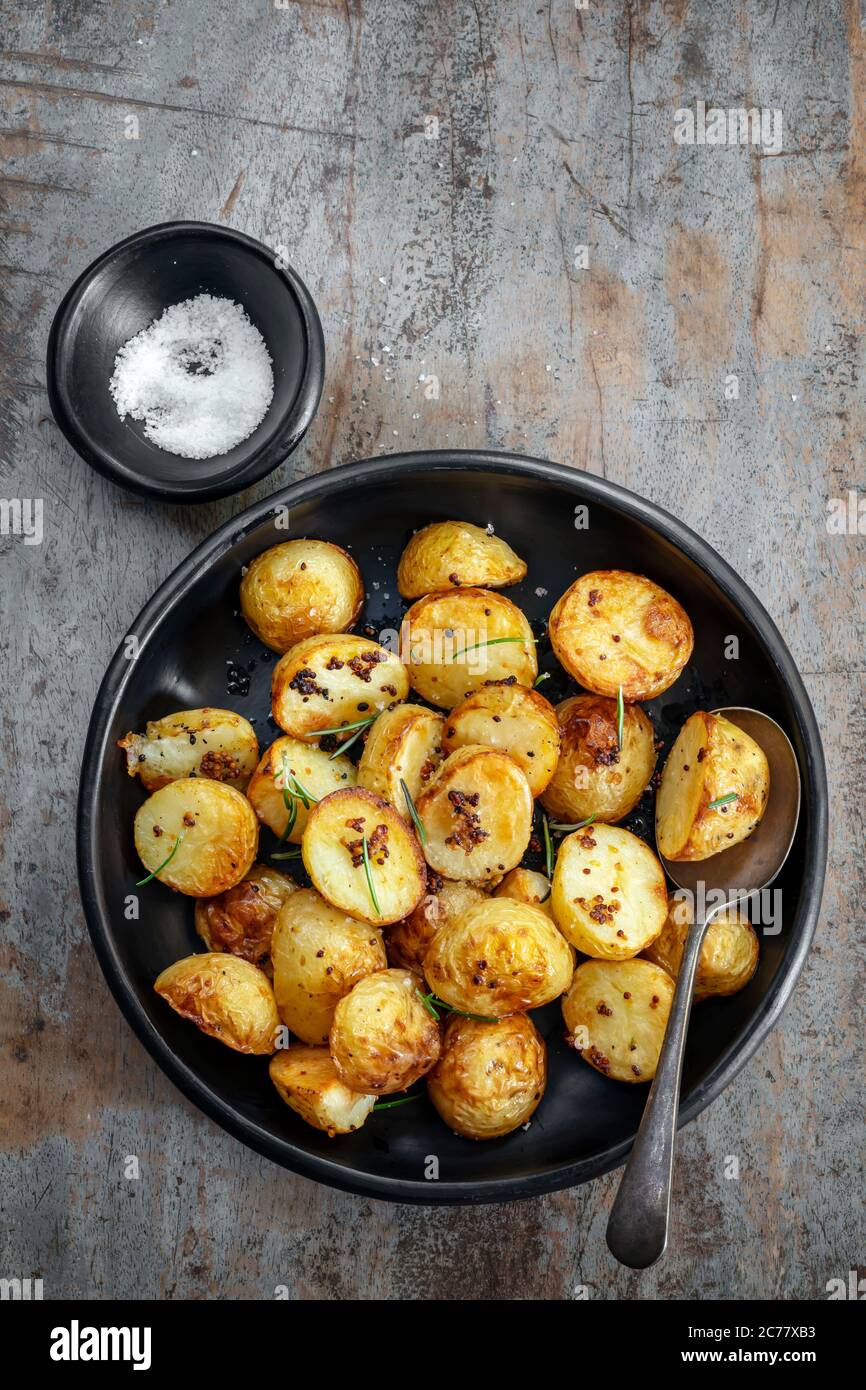 Roasted baby potatoes with wholegrain mustard and rosemary. Rustic ...