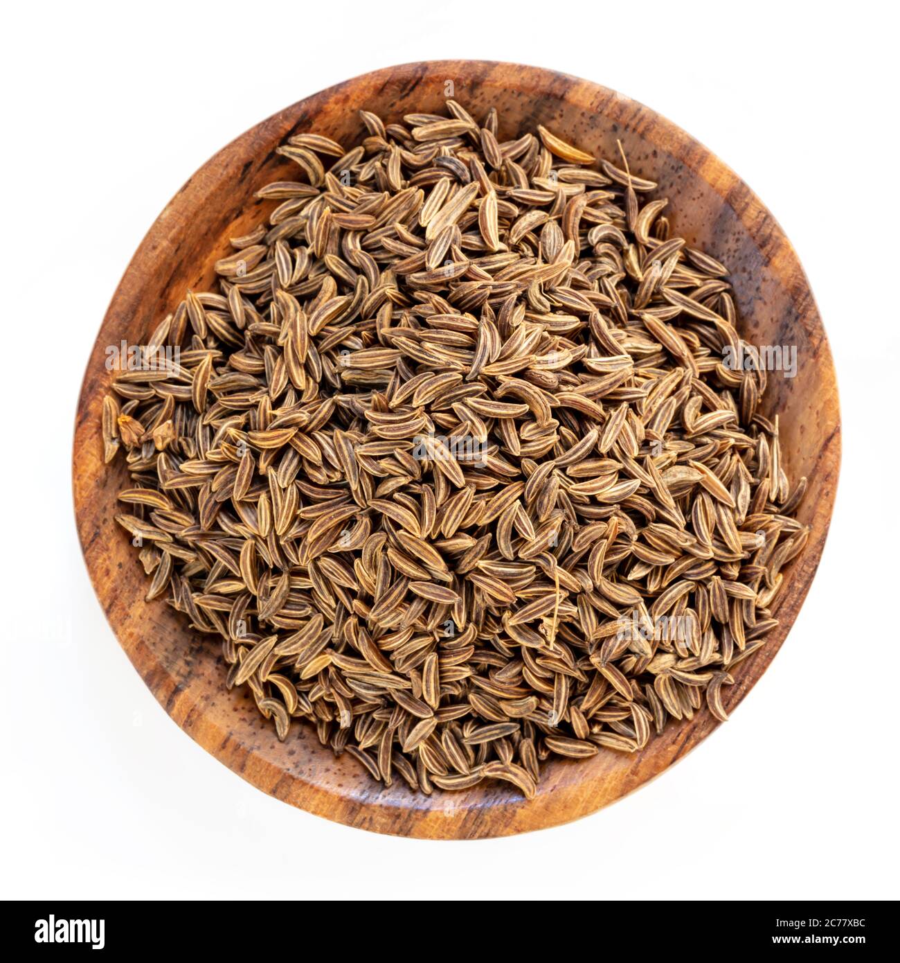 Caraway seeds in wooden bowl top view isolated on white Stock Photo - Alamy