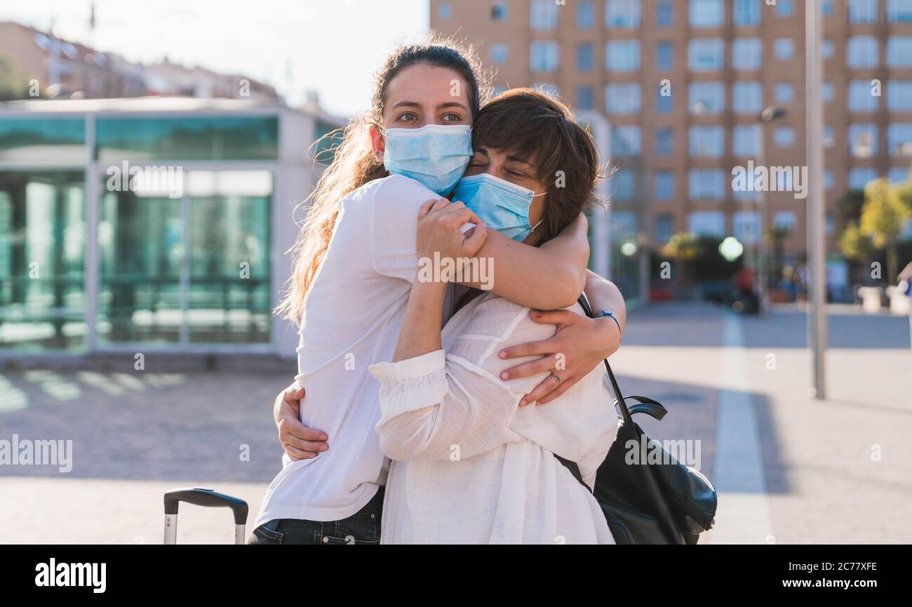 New normal. Mother and daughter embrace each other within the new ...