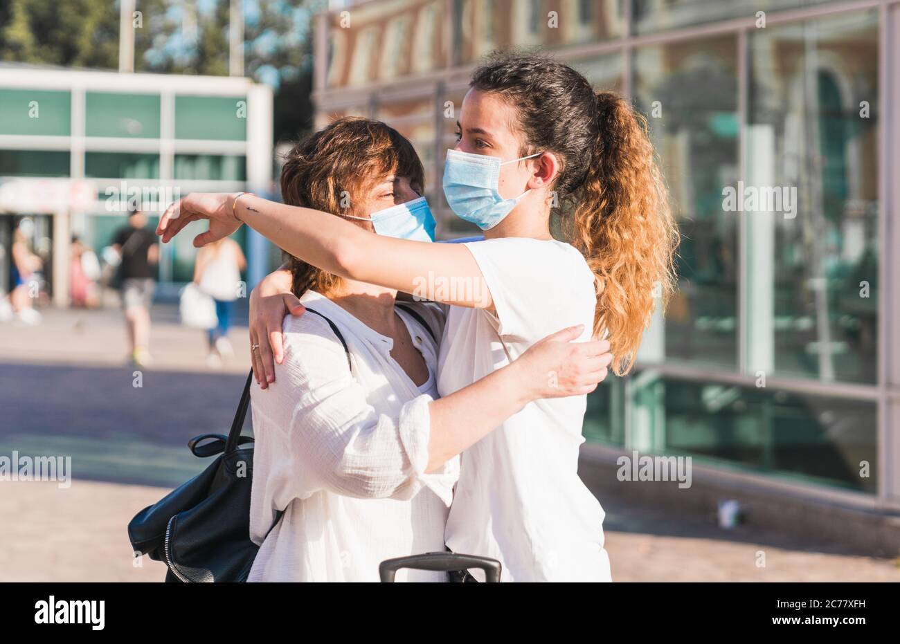 New normal. Mother and daughter embrace each other within the new ...