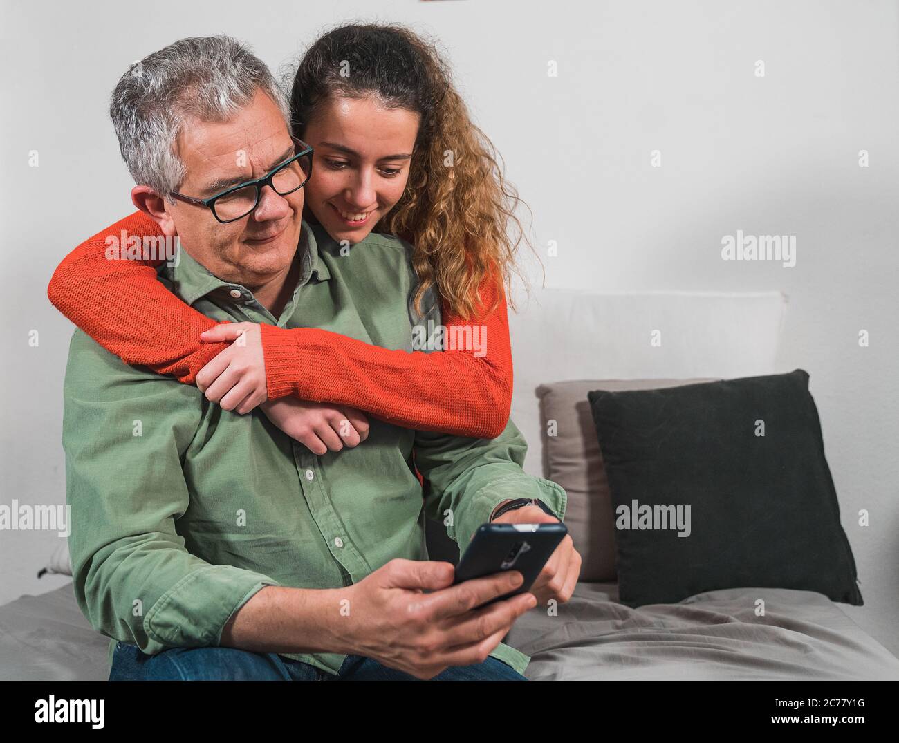 Father and daughter in each other's arms. Family having a video call ...