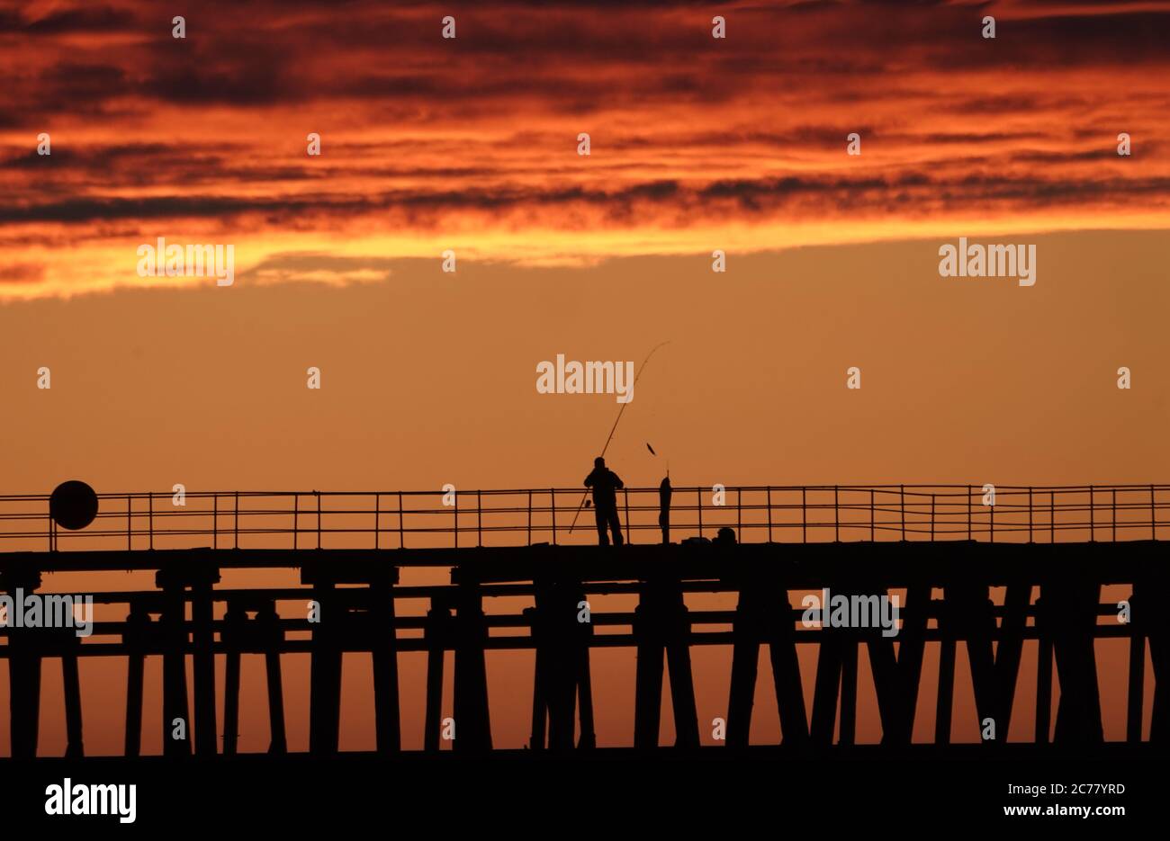 Fishermen on Blyth pier in Northumberland, fishing for mackerel as the ...