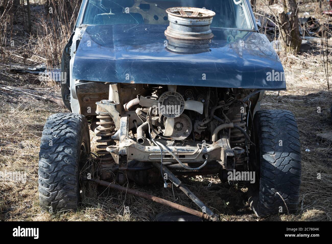 Old broken blue SUV car, engine parts and transmission details Stock ...
