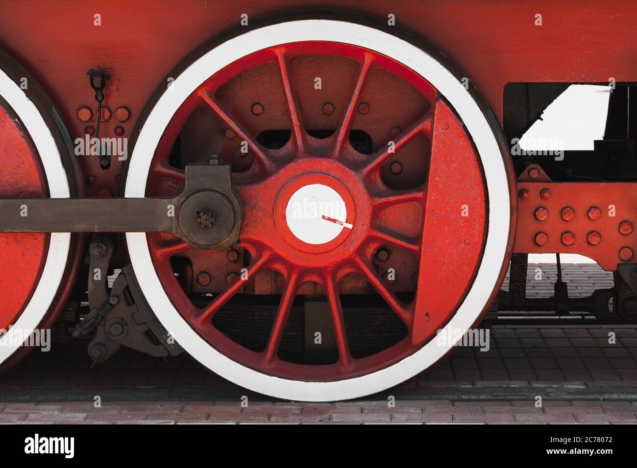 Red white wheel of vintage steam locomotive with connecting rod, close ...