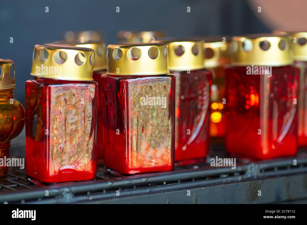 Church candles and lamps for the repose in a catholic church. Christian ...