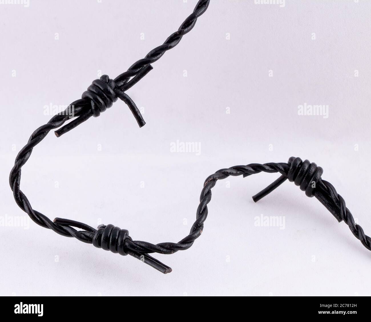 Three barbs strand of black Barbed Wire on white background Stock Photo ...