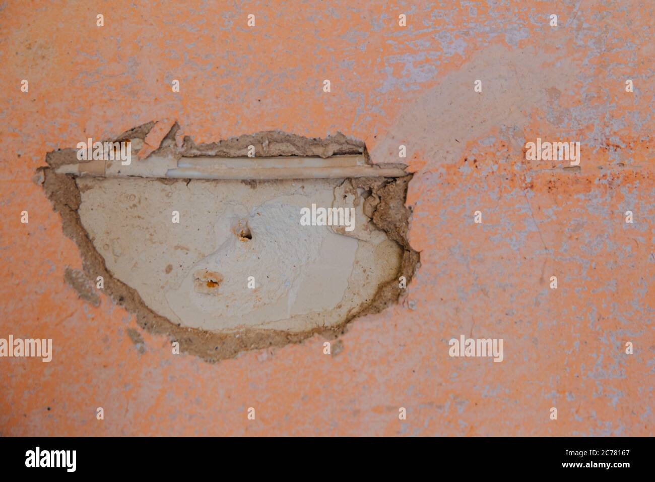 The old wall that is crumbling. You can see a brick wall and a piece of ...