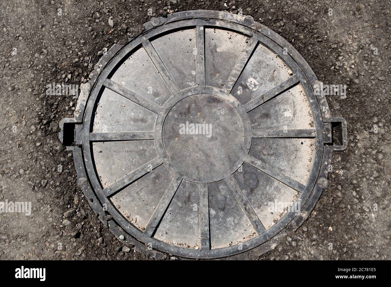 Grunge manhole. Plastic manhole, manhole cover on asphalt street ...