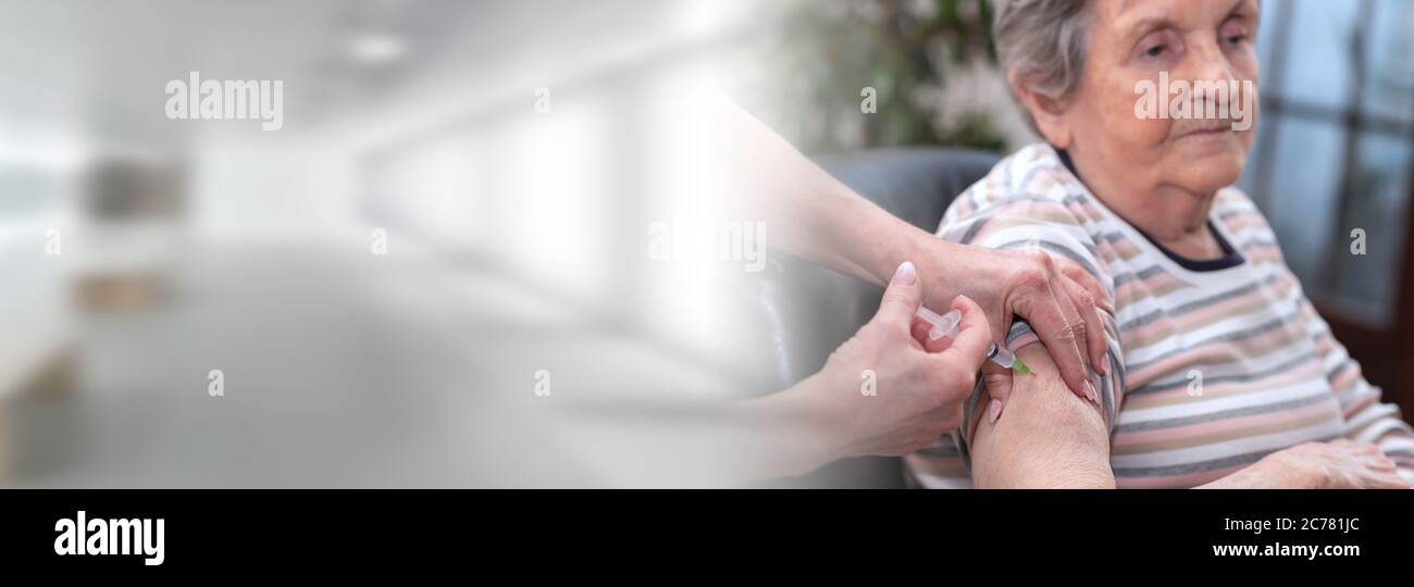 Nurse giving an injection to senior woman; panoramic banner Stock Photo ...