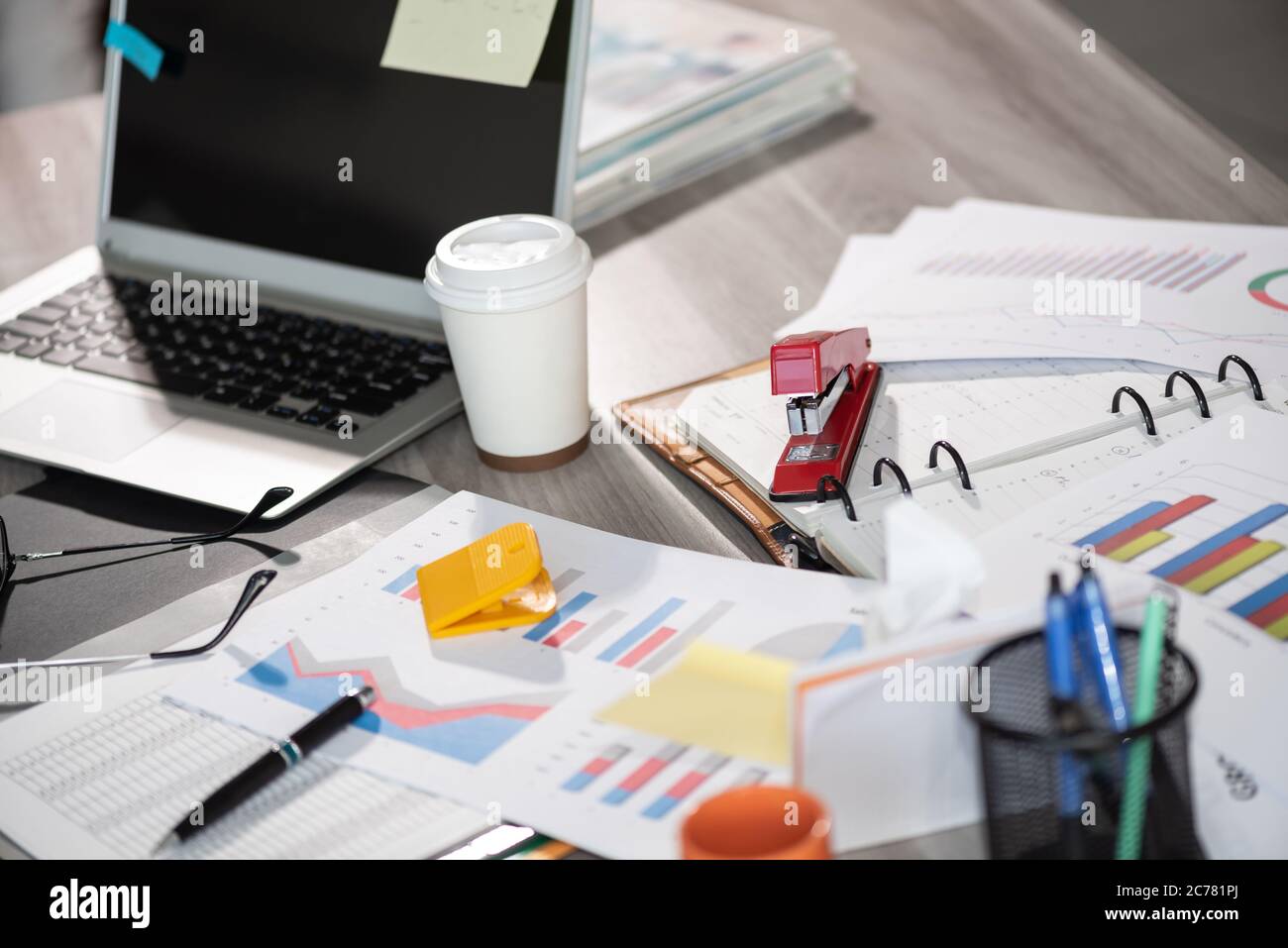 Messy and cluttered office desk Stock Photo - Alamy