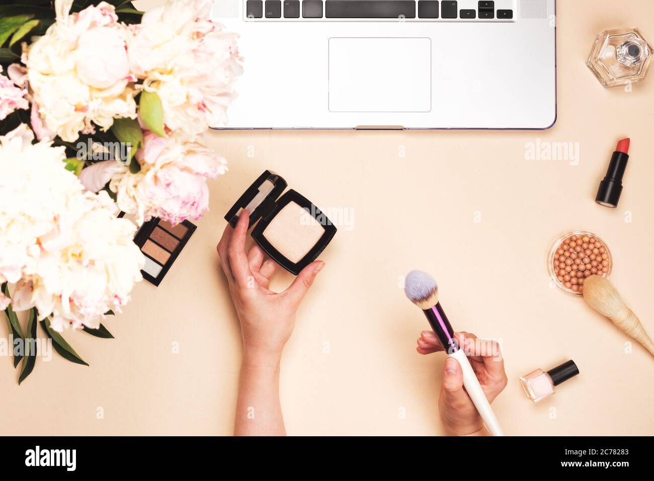 Beauty blogger workspace with laptop and cosmetics and peony Stock ...