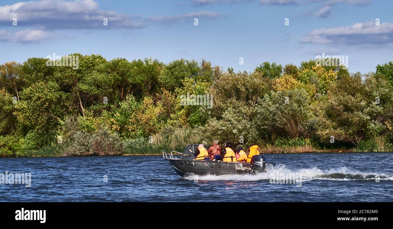 A boat transporting a family in the volga estuary hi-res stock ...