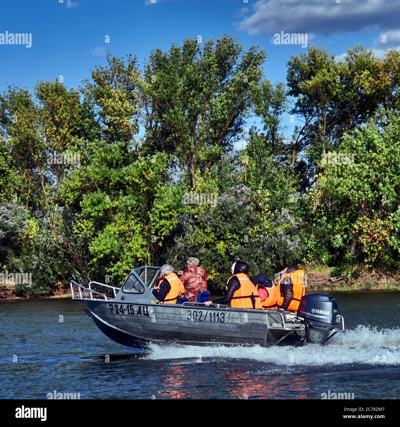 Russia,Astrakhan Oblast, Volga Delta, A boat transporting a family in ...