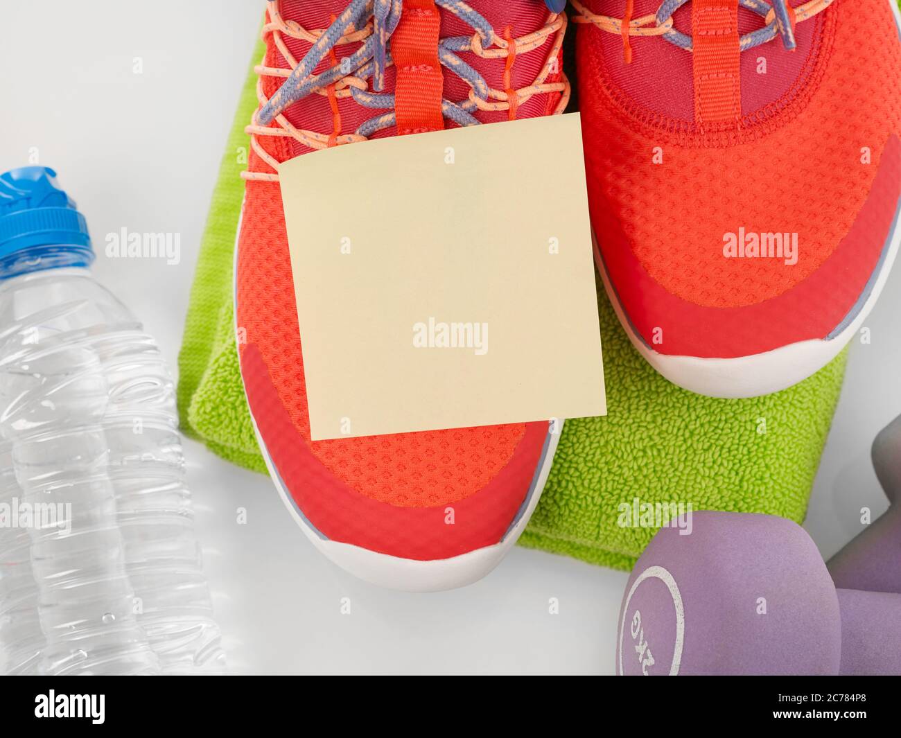Blank adhesive note and sport equipment Stock Photo - Alamy