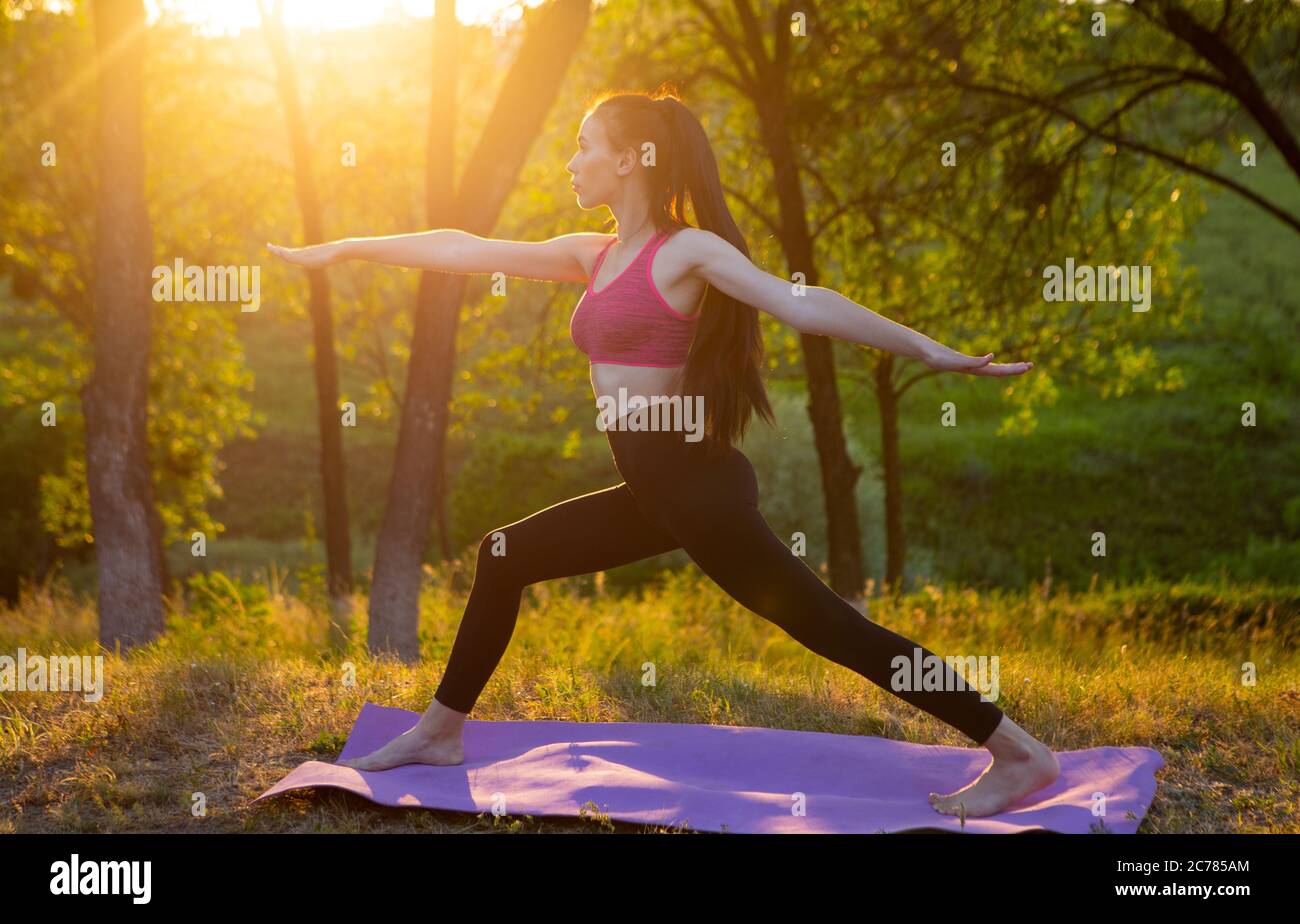 Woman is doing exercise on beautiful nature in the background Stock ...