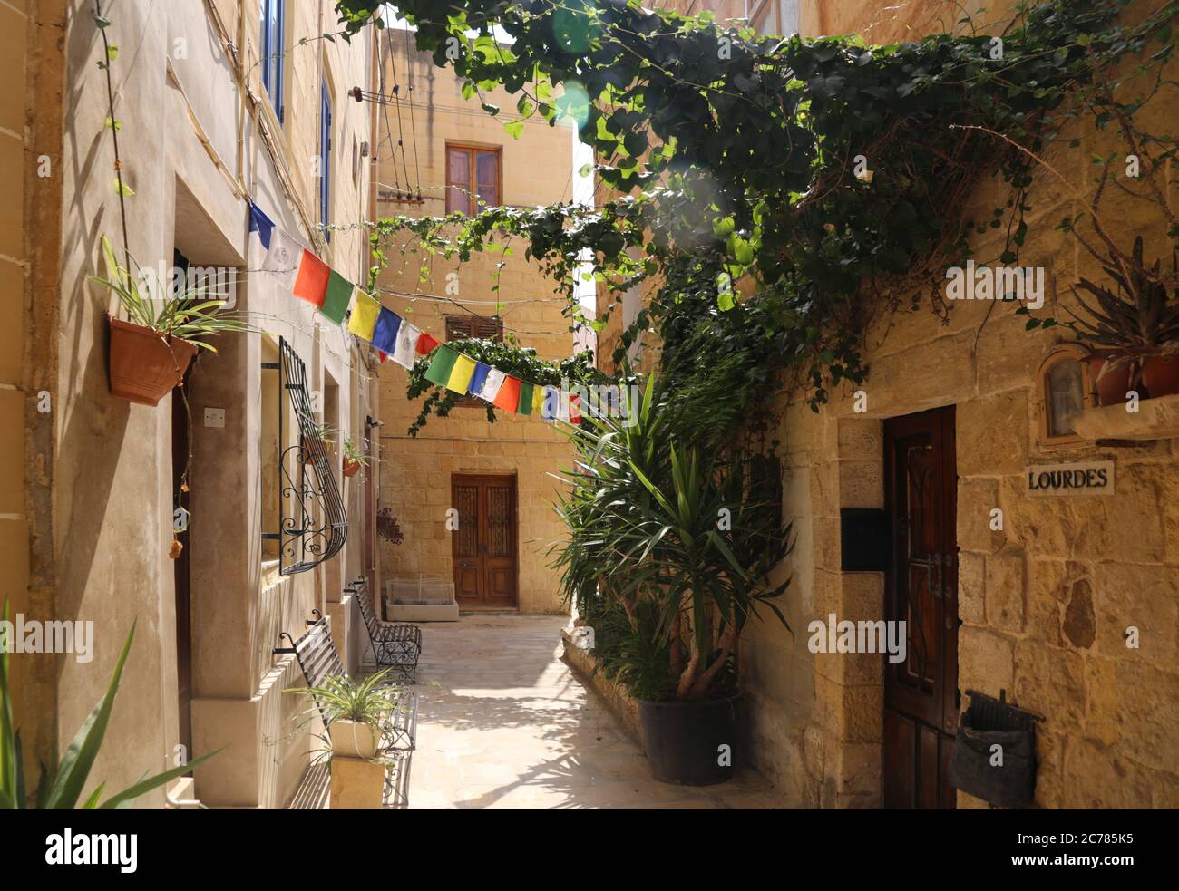 Bormla. (Citta Cospicua). Malta. Small lane with colorfull flags ...