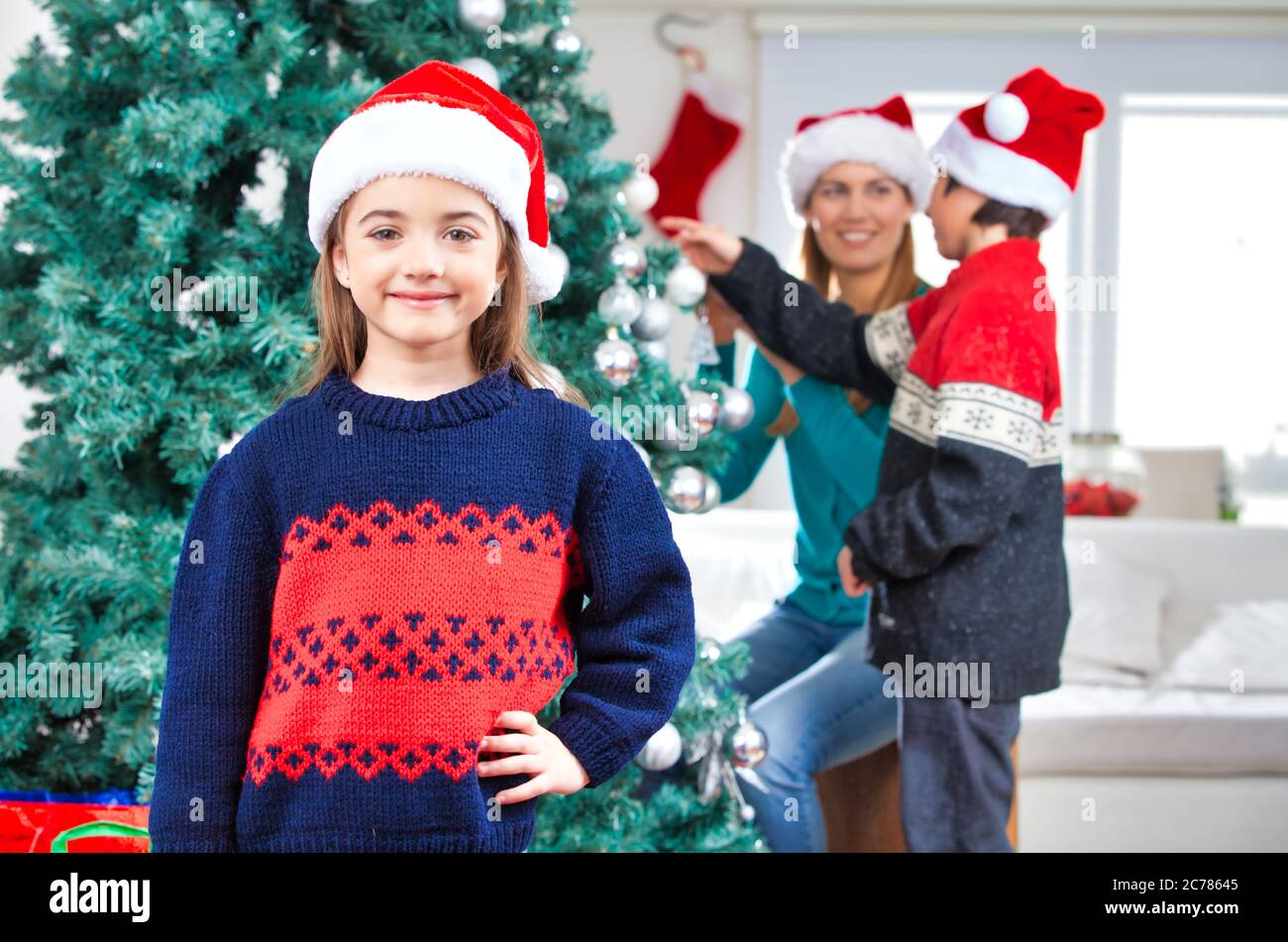 Christmas scene at home. Happy family under the tree Stock Photo - Alamy