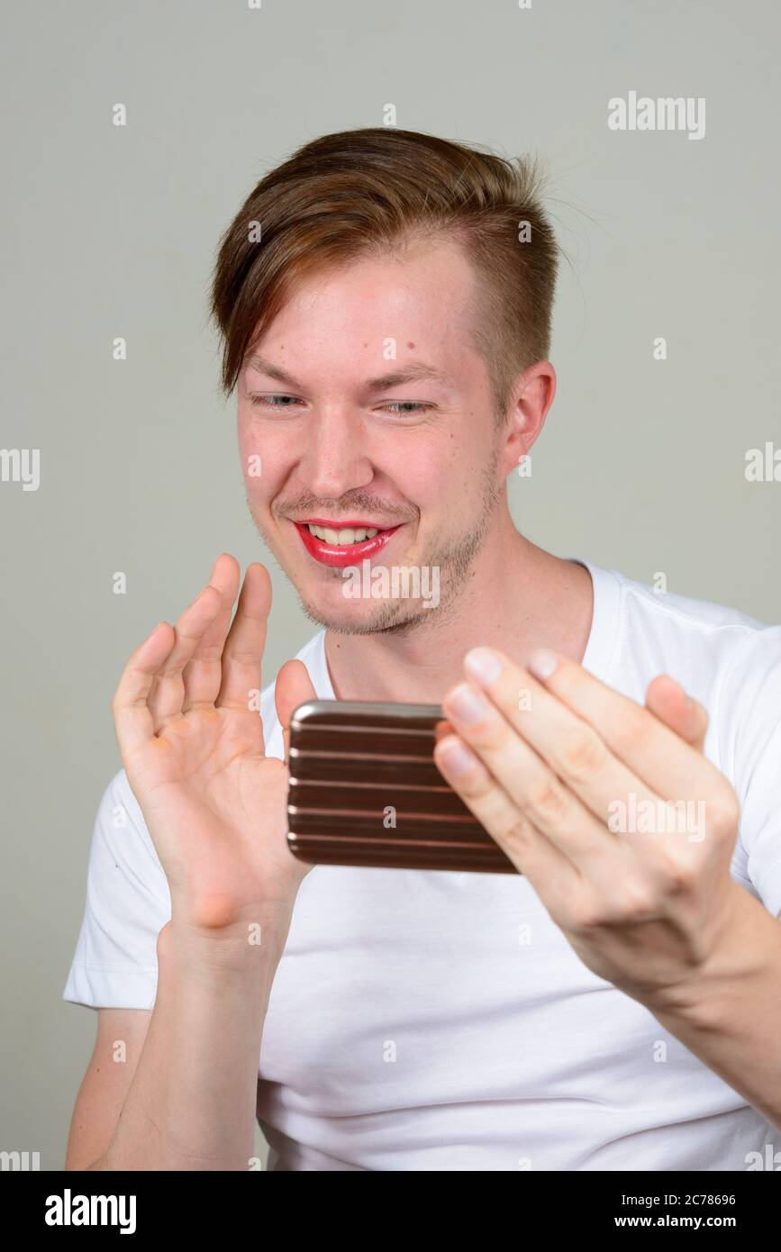 Portrait of young man with beard stubble wearing makeup Stock Photo - Alamy
