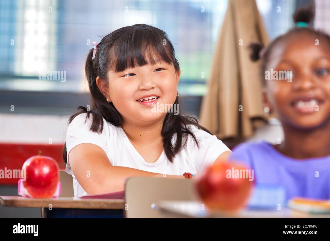 Elementary school scene. African schoolgirl with multi asian classmate ...
