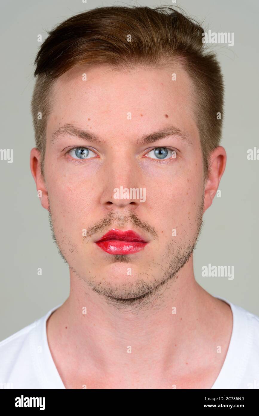 Portrait of young man with beard stubble wearing makeup Stock Photo - Alamy