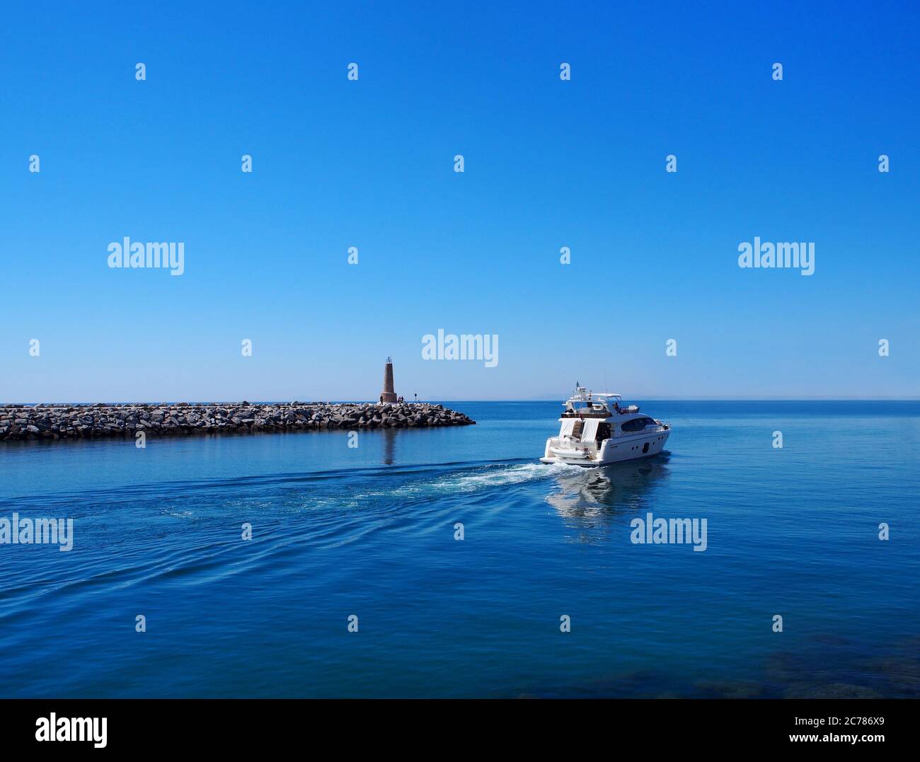 Lighthouse and boat Stock Photo - Alamy