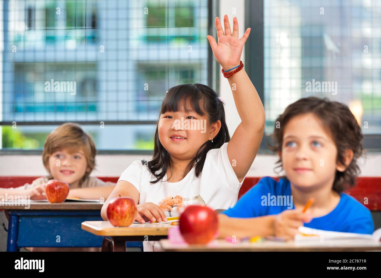 Elementary school scene. Multi ethnic classmates in the classroom Stock ...