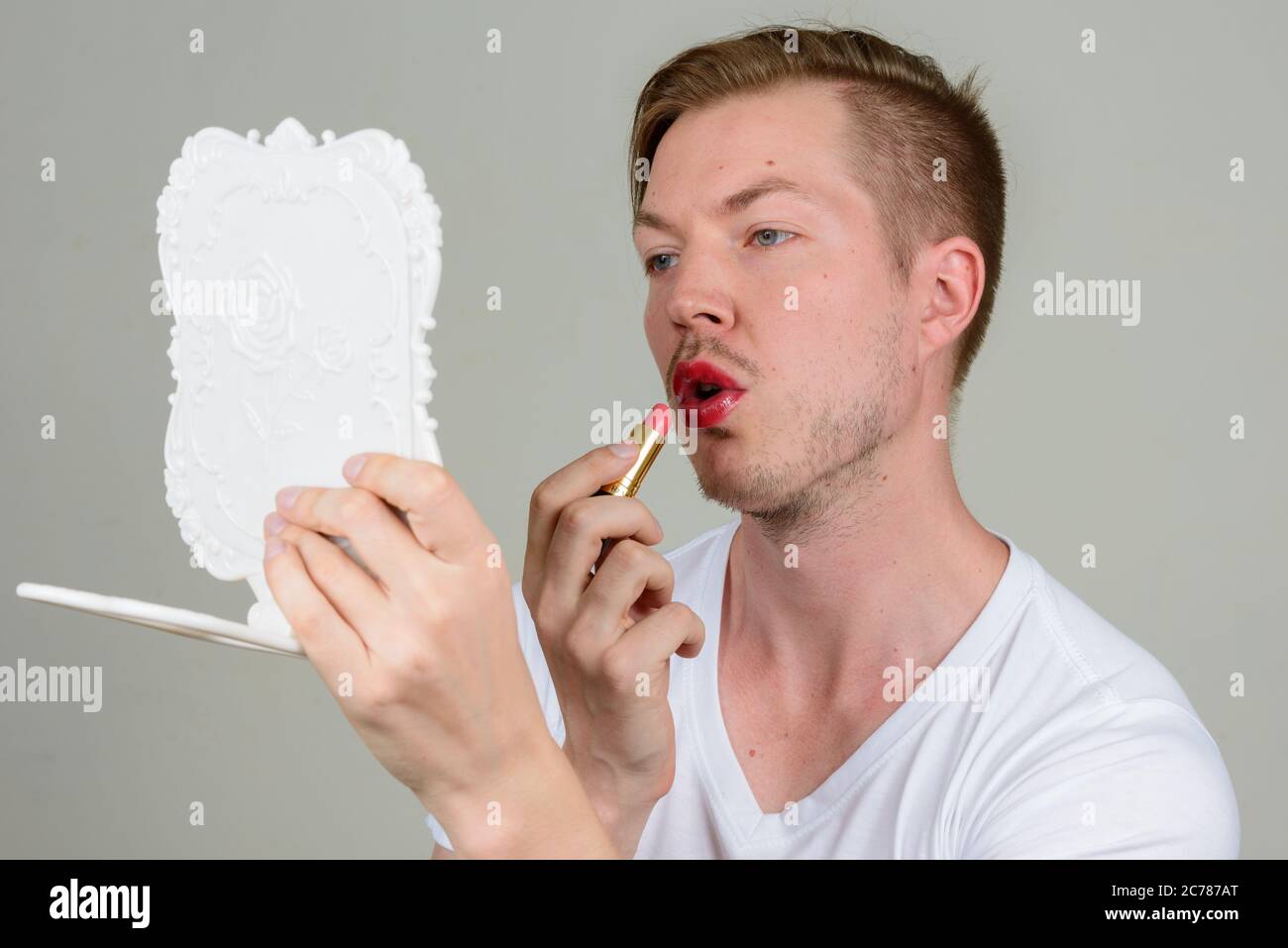 Portrait of young man with beard stubble wearing makeup Stock Photo - Alamy