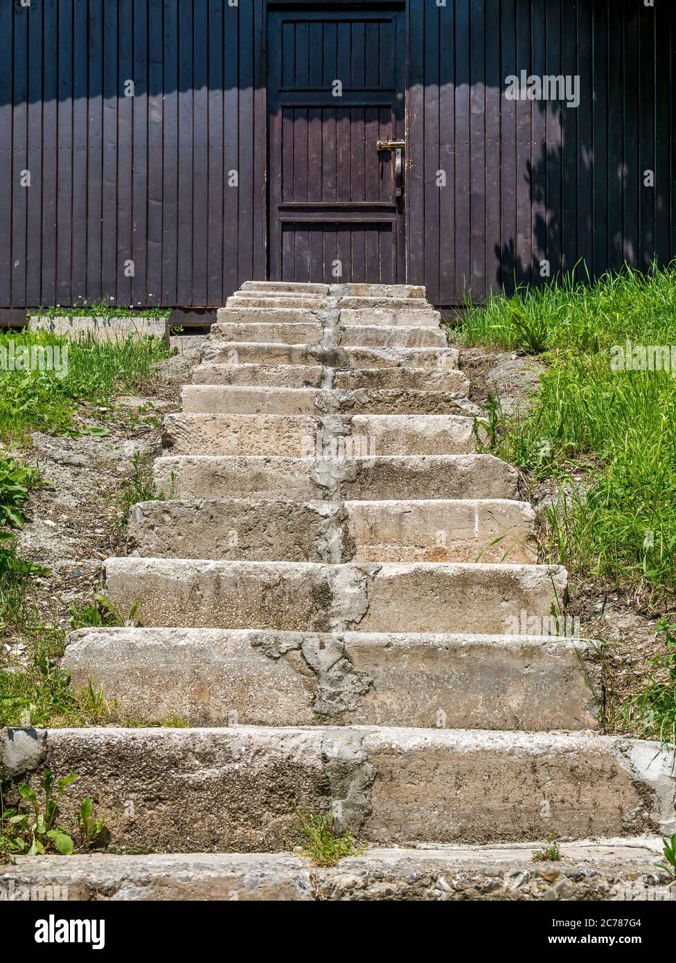 Worn out stone stairs leading to a closed door Stock Photo - Alamy