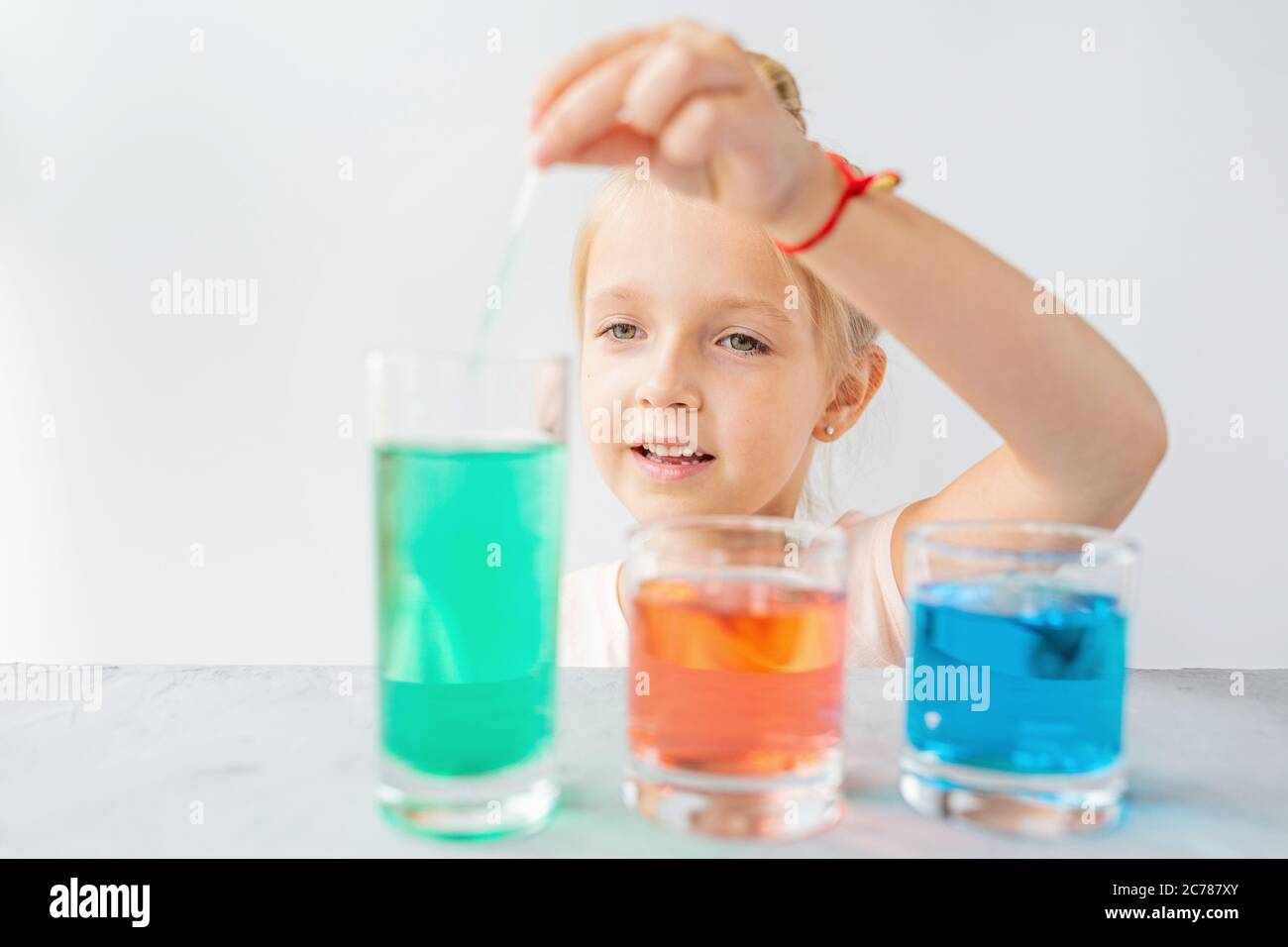 cute little girl six years old doing laboratory experiment with ...