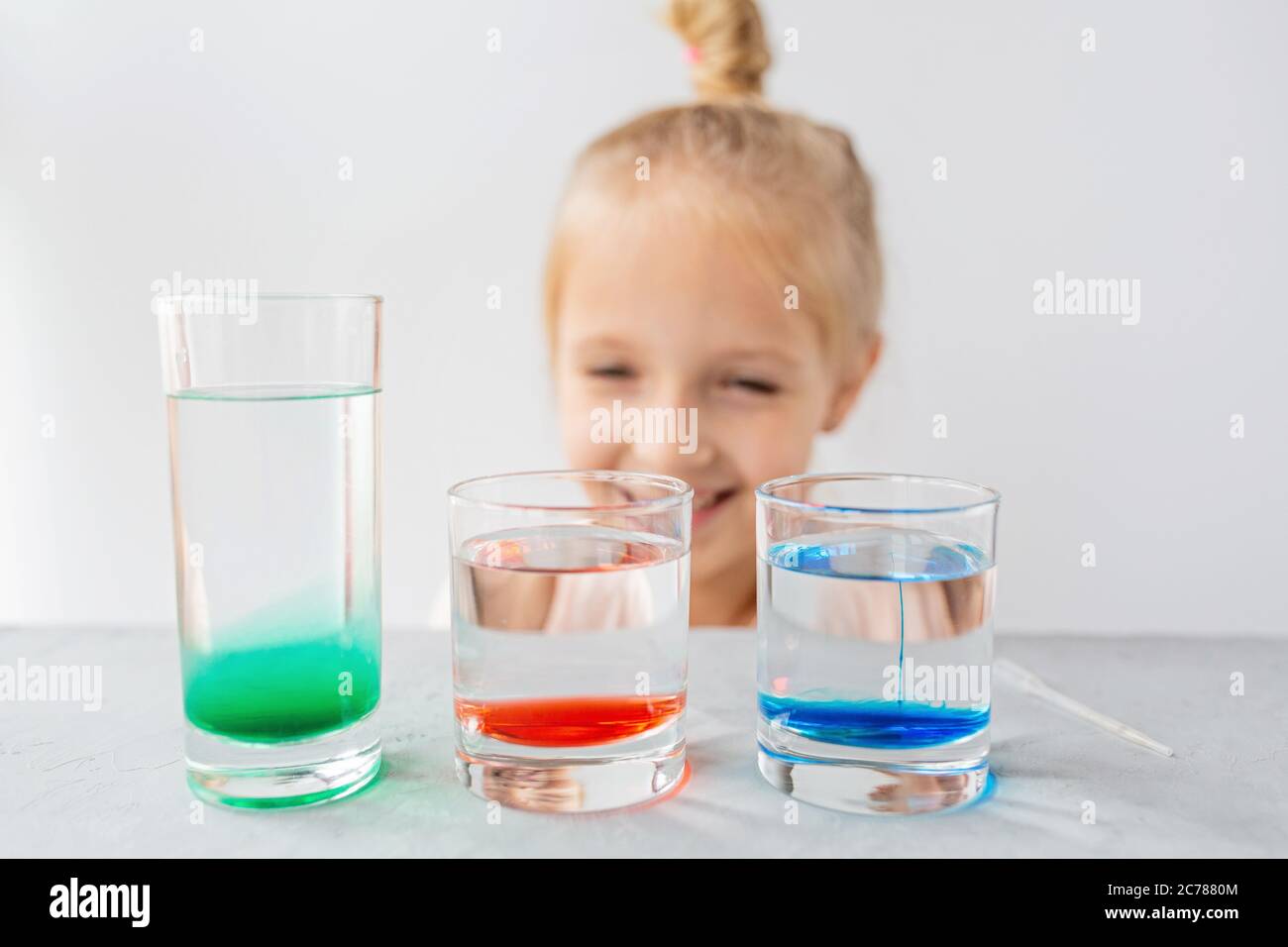 cute little girl six years old doing laboratory experiment with ...