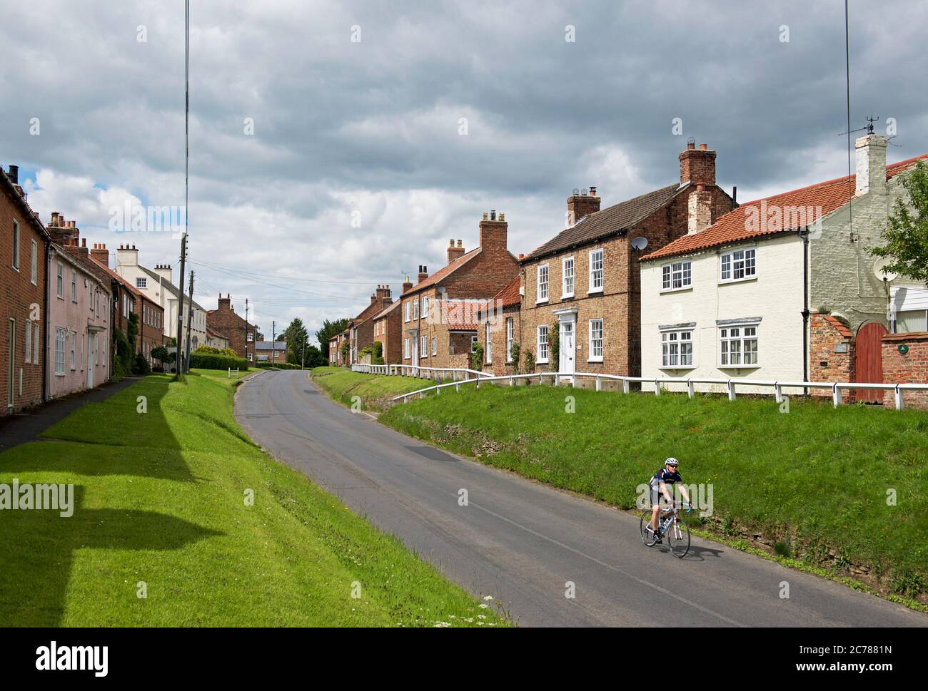 Male cyclist in the village of Stillington, North Yorkshire, England UK ...