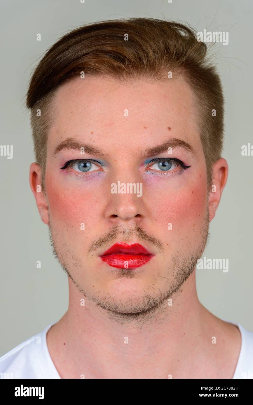 Portrait of young man with beard stubble wearing makeup Stock Photo - Alamy