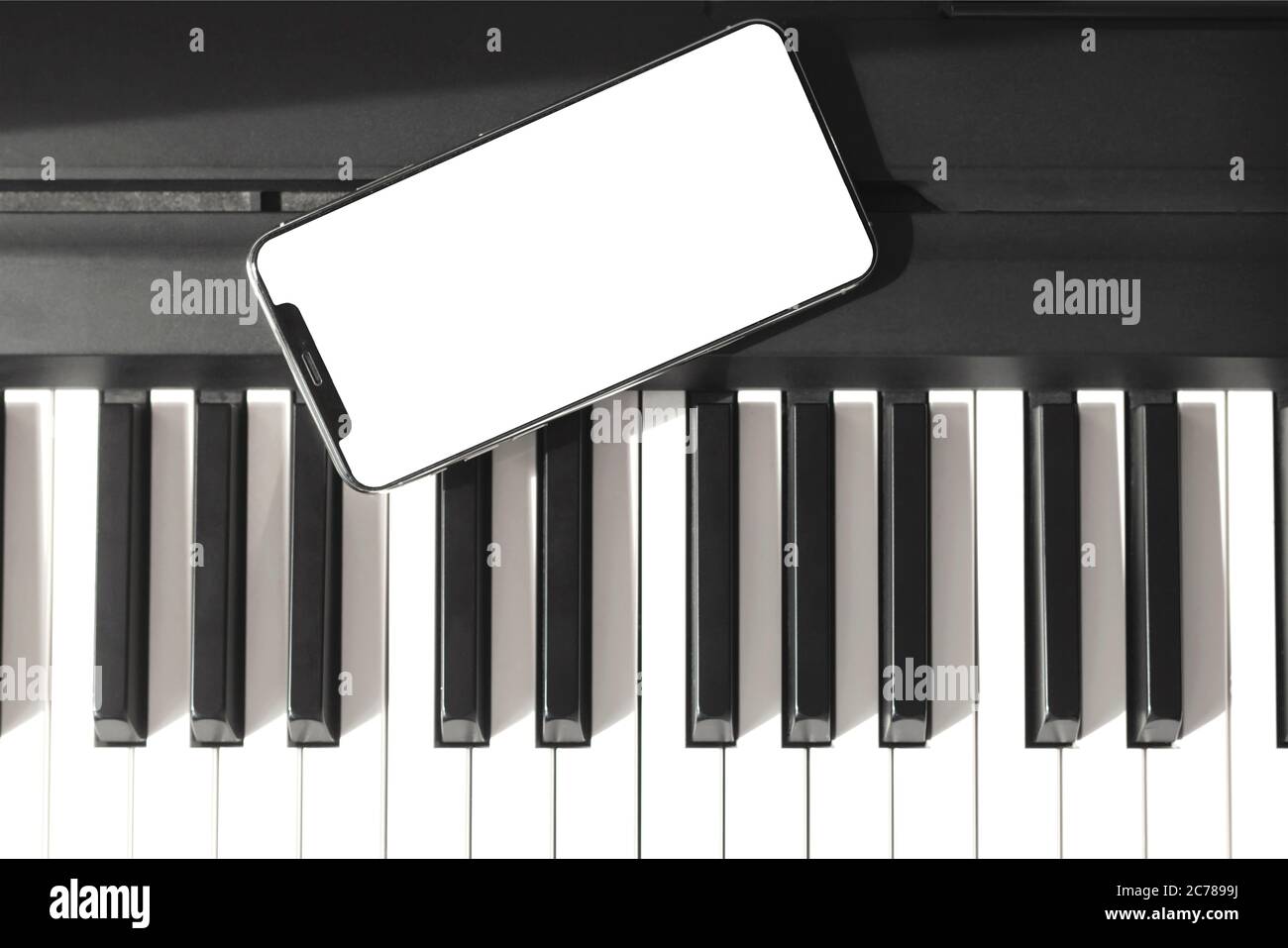 Isolated smartphone screen on electronic piano. Top view Stock Photo ...