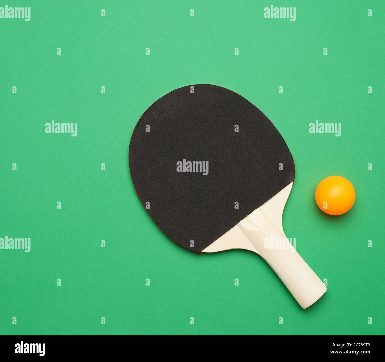 black wooden racket and plastic orange table tennis ball, top view ...