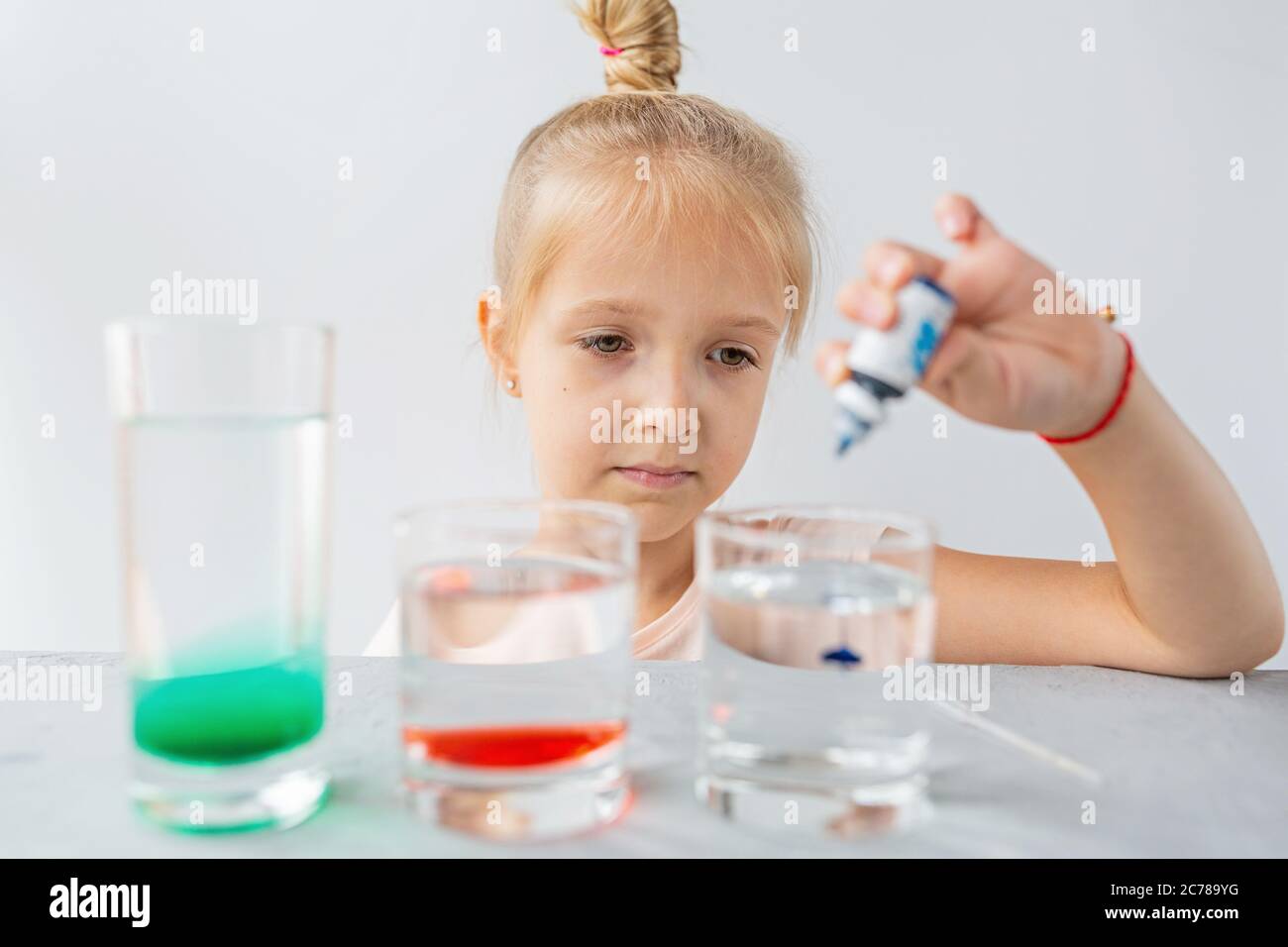 cute little girl six years old doing laboratory experiment with ...