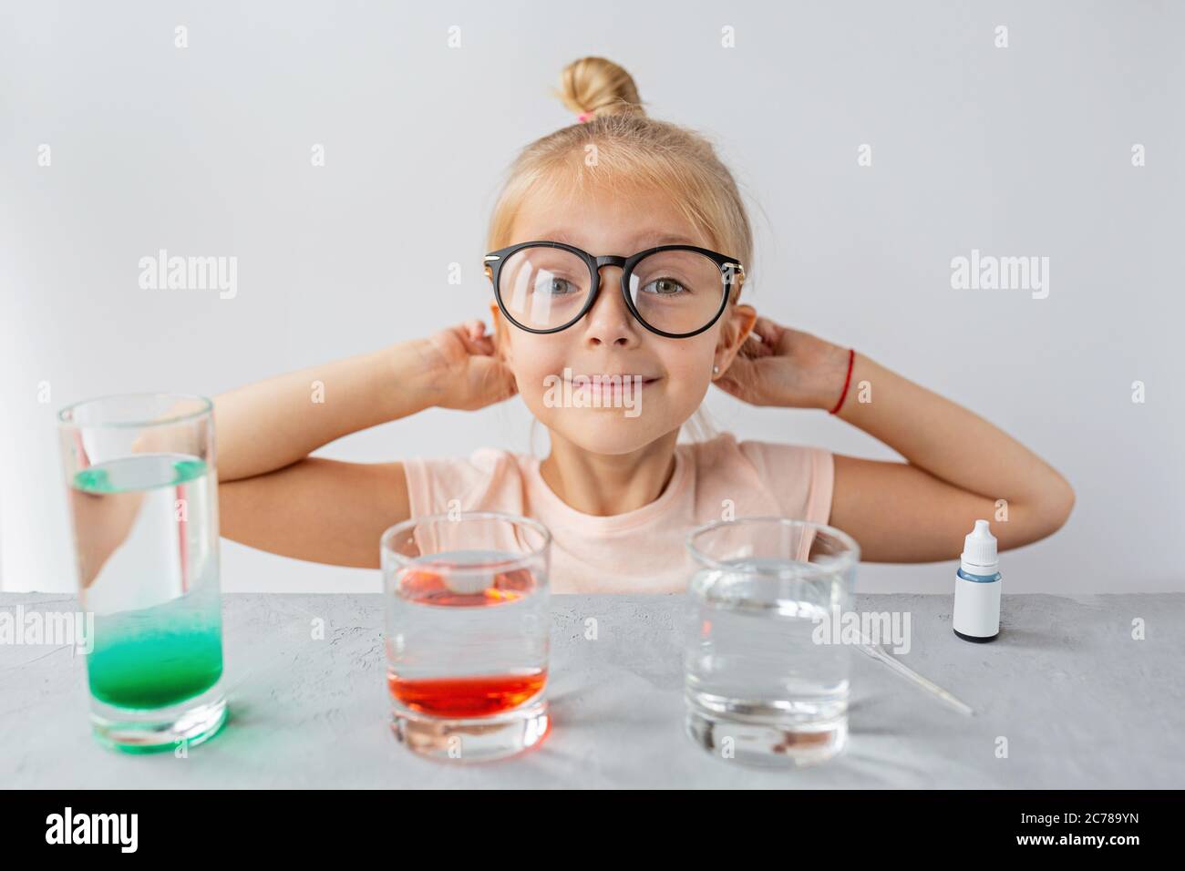 cute little girl six years old doing laboratory experiment with ...
