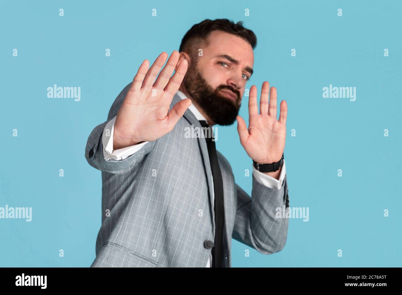 Portrait of millennial businessman refusing something, showing STOP ...