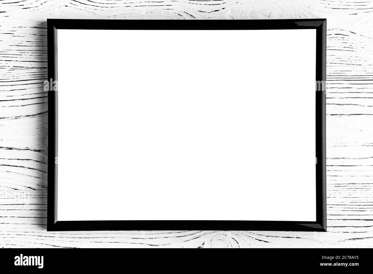 Black photo frame on a white wooden table. Abstract background for ...