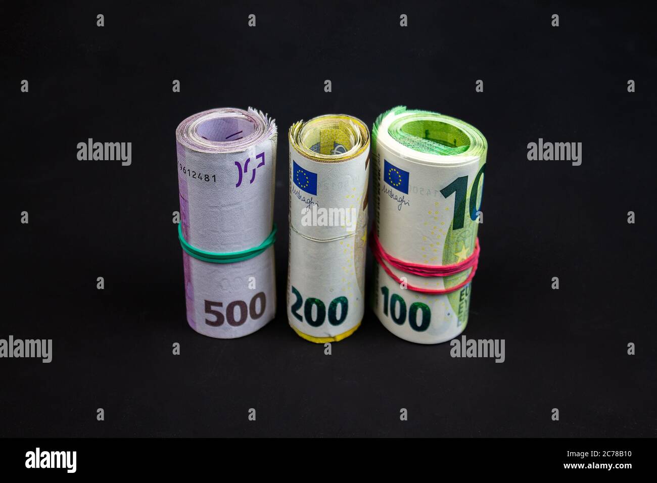 Standing and rolled euro notes. 100, 200 and 500 banknotes. A total of ...