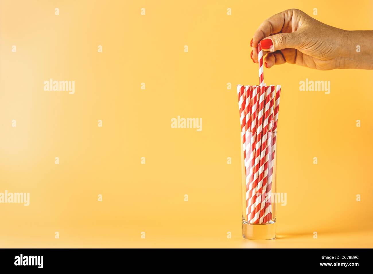 Female hand picking drinking paper straw. Colorful paper disposable eco ...