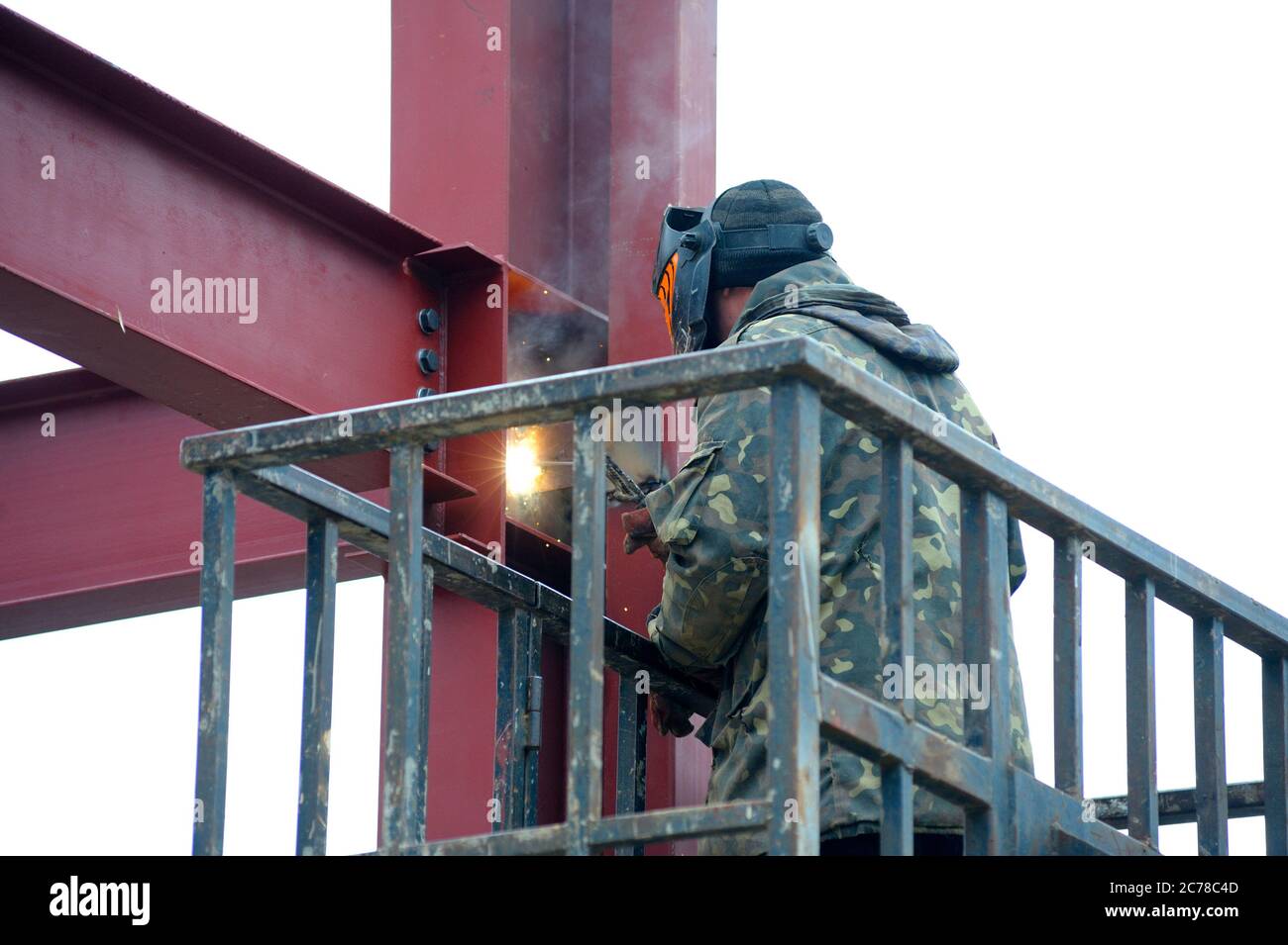 Worker welding metal carcass using truck mounted lift Stock Photo - Alamy